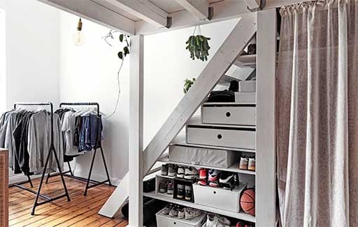 Use an awkward space under the stairs for storage - IKEA